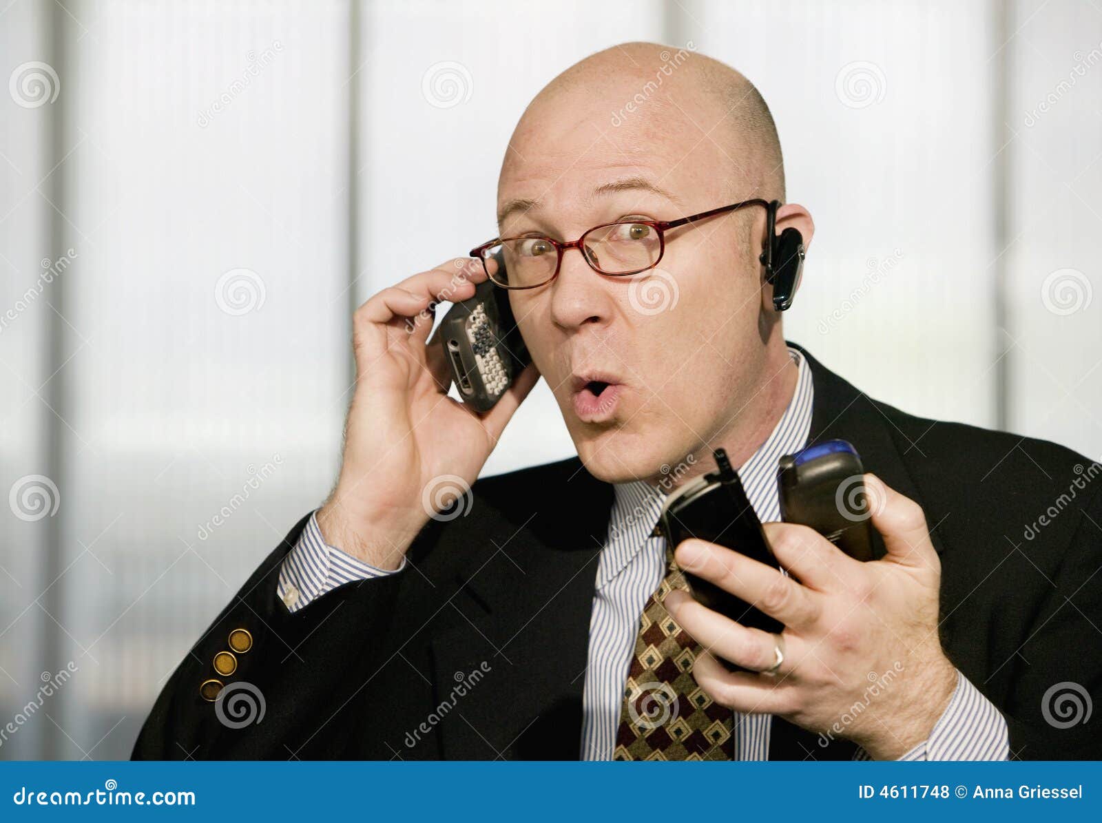 Businessman with Multiple Cell Phones Stock Photo - Image of human ...
