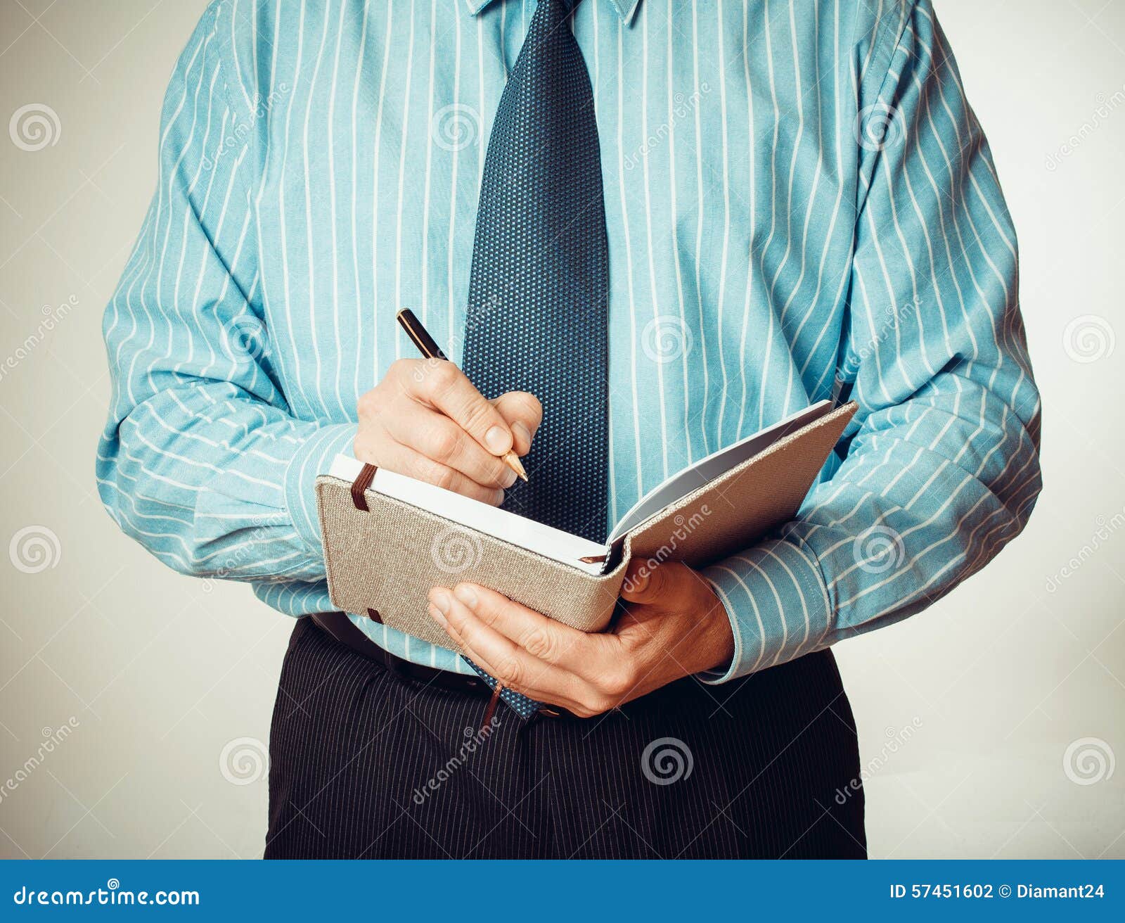 Businessman with Notebook and Pen Writing Stock Photo - Image of ...
