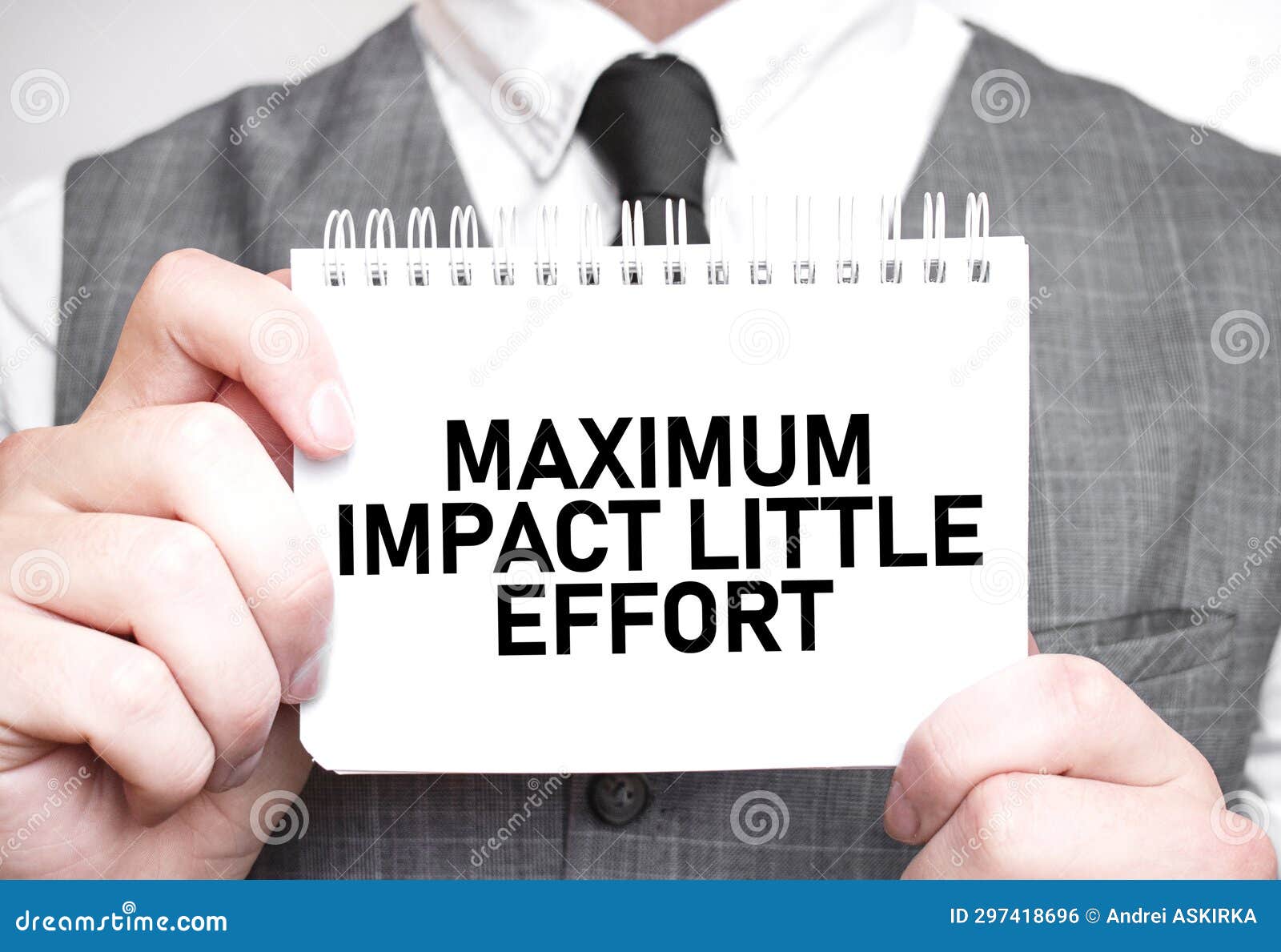 Businessman with Notebook with Text MAXIMUM IMPACT LITTLE EFFORT Stock ...