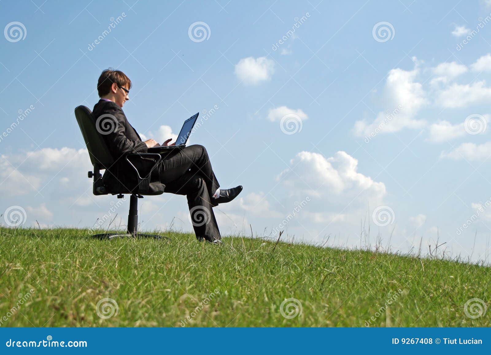 Businessman on Office Chair Working with a Laptop Stock Photo - Image ...