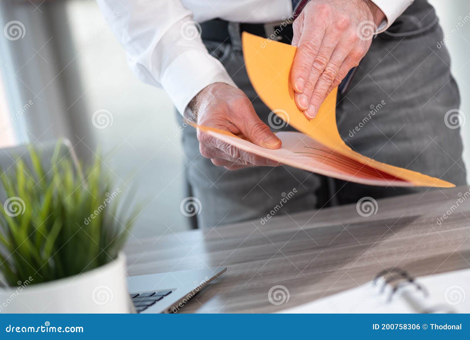 Businessman opening folder stock photo. Image of office - 200758306