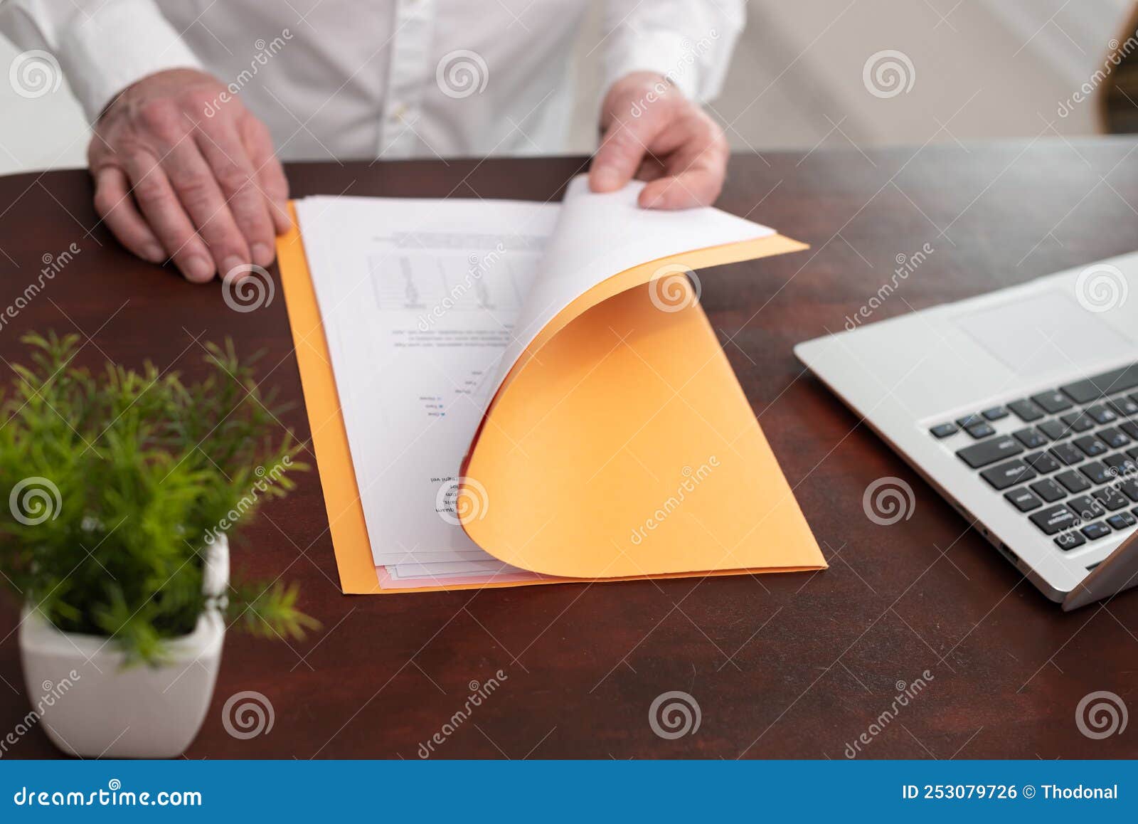 Businessman opening folder stock photo. Image of person - 253079726