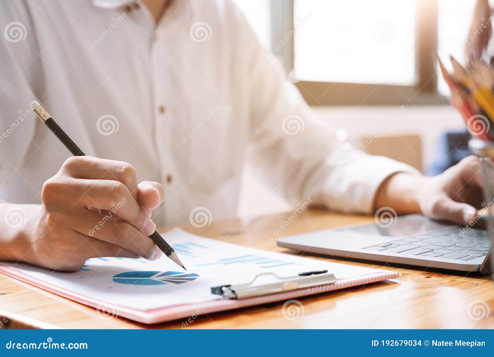 Businessman Pen Pointing Turnover with Graph Chart Report and Use ...