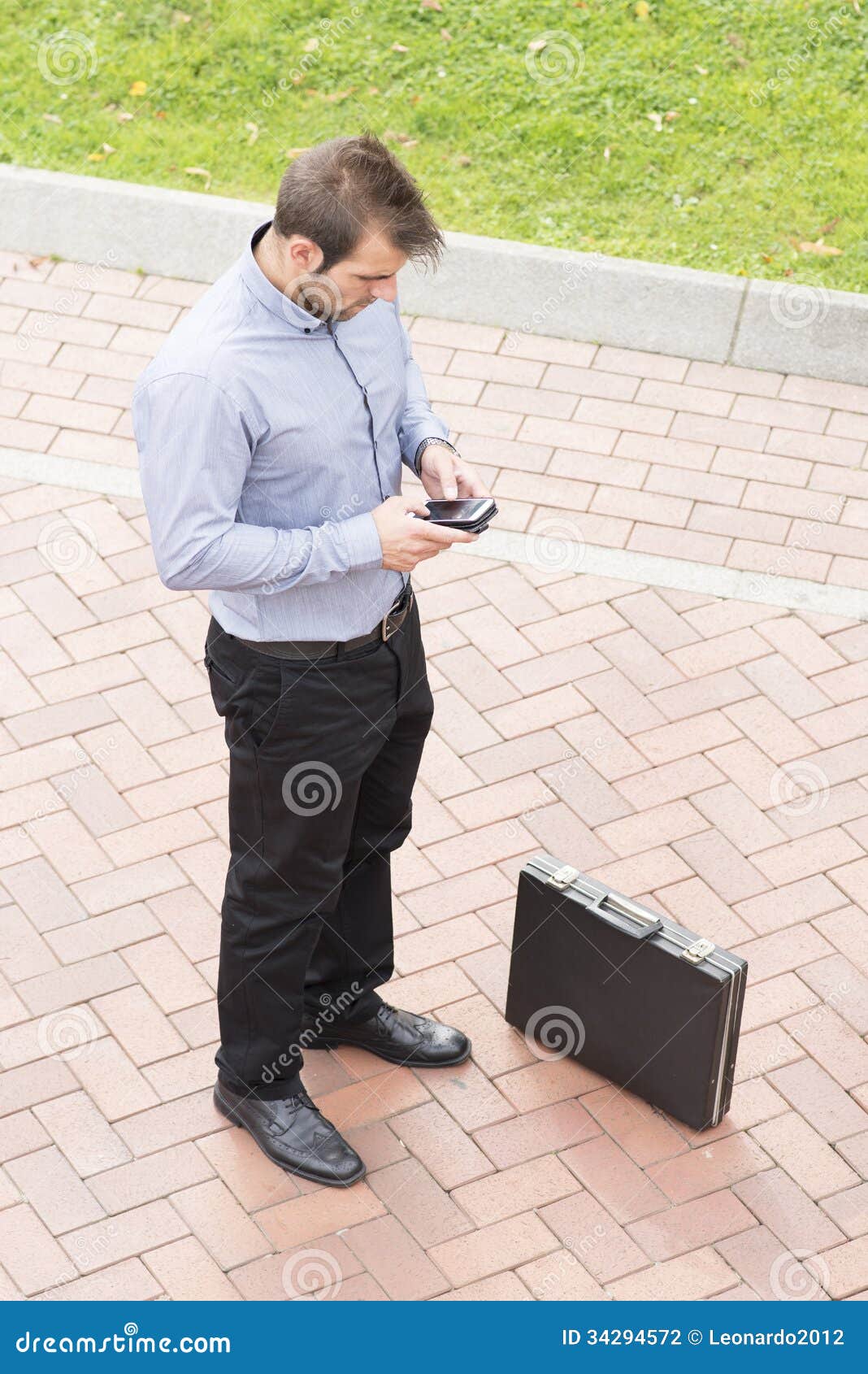 Businessman with Phone and Briefcase in the Street. Stock Photo - Image ...