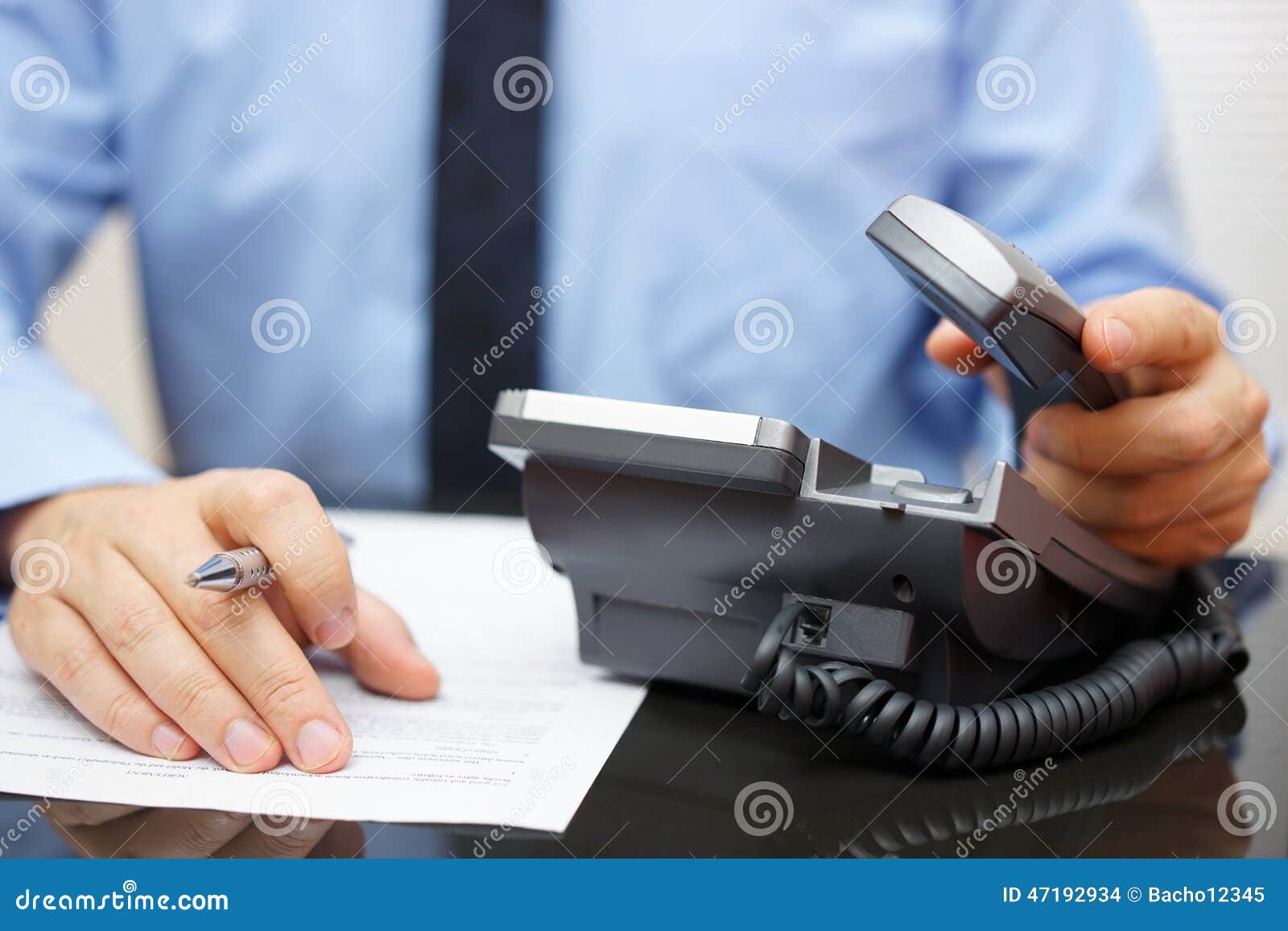Businessman is Picking Up the Headset for Help, while Reading Le Stock ...