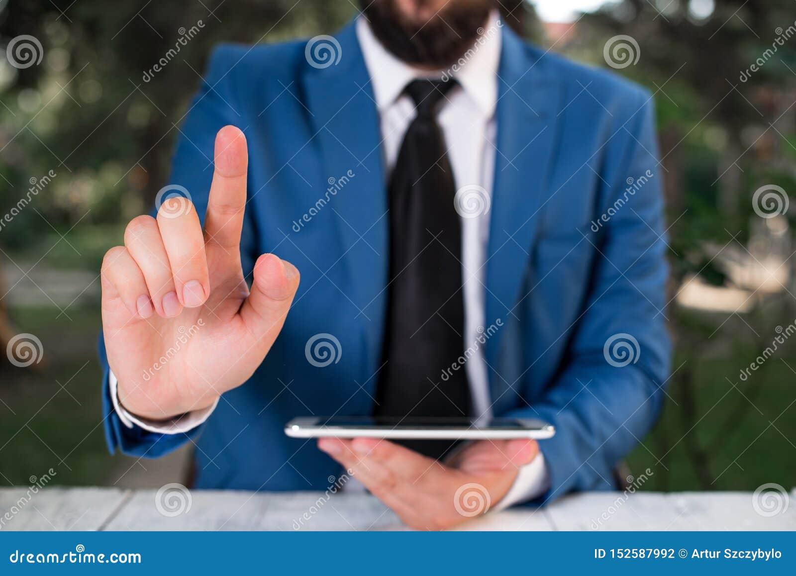 Businessman with Pointing Finger in Front of Him. Businessman Holds Lap ...
