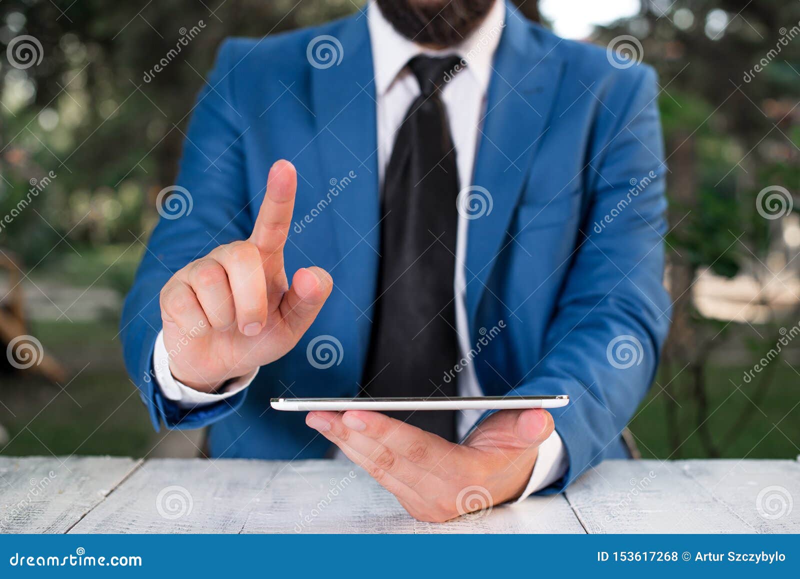 Businessman with Pointing Finger in Front of Him. Businessman Holds Lap ...