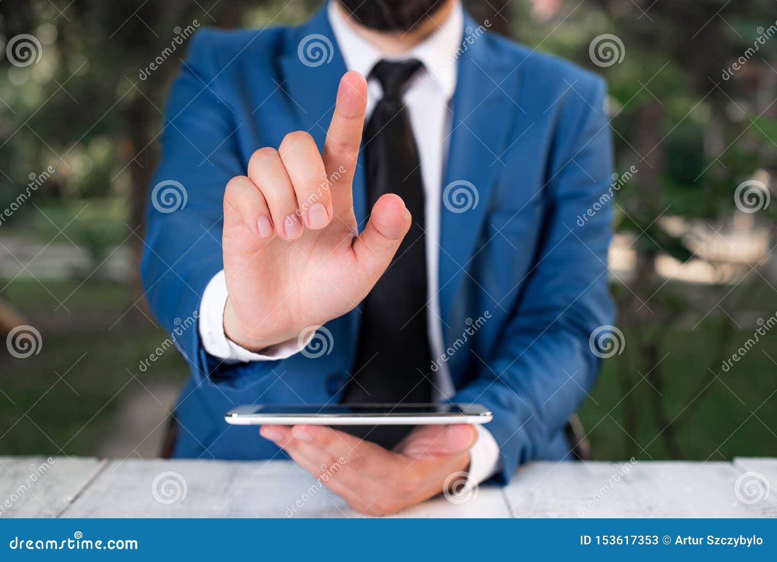 Businessman with Pointing Finger in Front of Him. Businessman Holds Lap ...