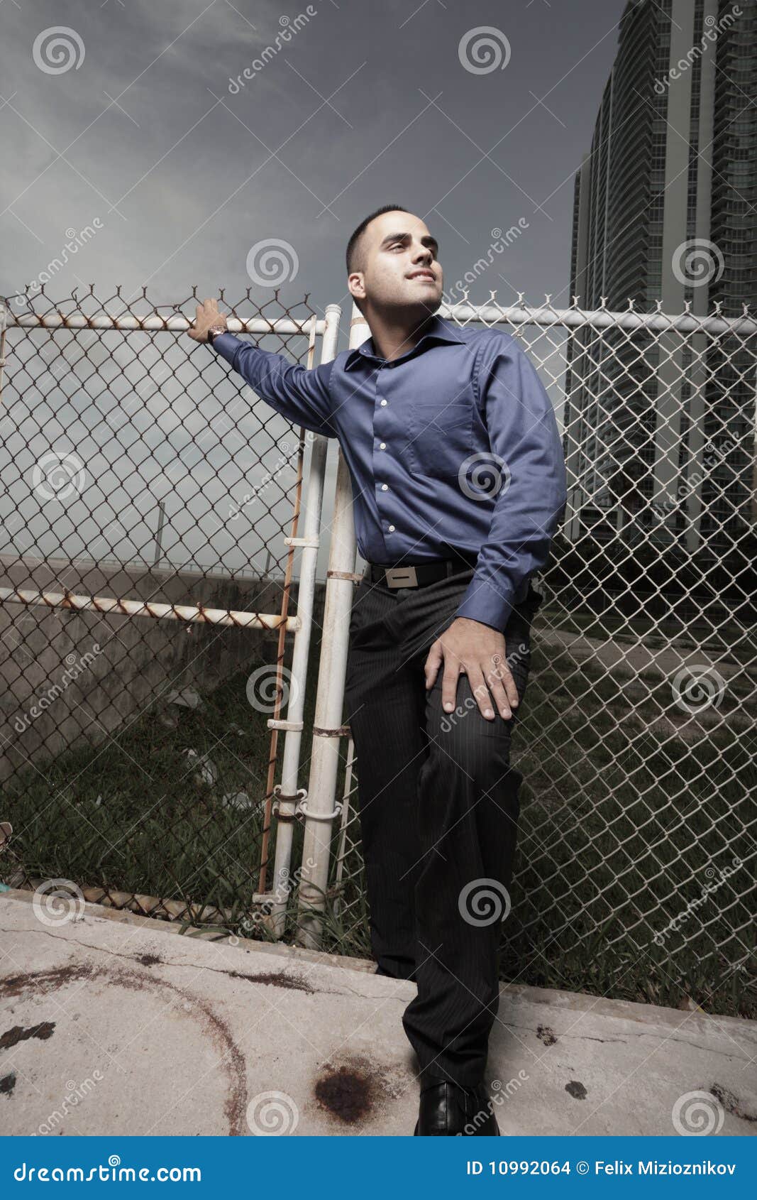 Businessman Posing by a Fence Stock Photo - Image of person, chainlink ...
