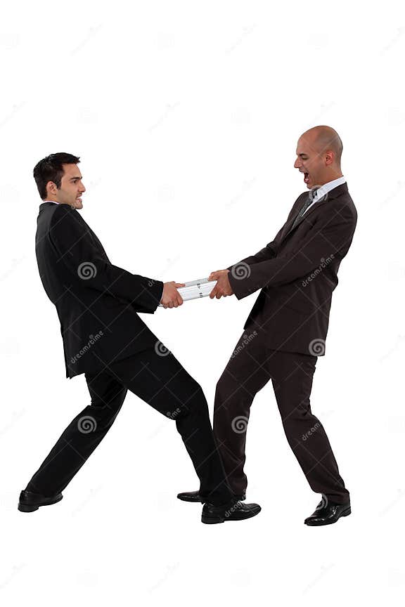 Businessman Pulling in Different Directions Stock Photo - Image of ...