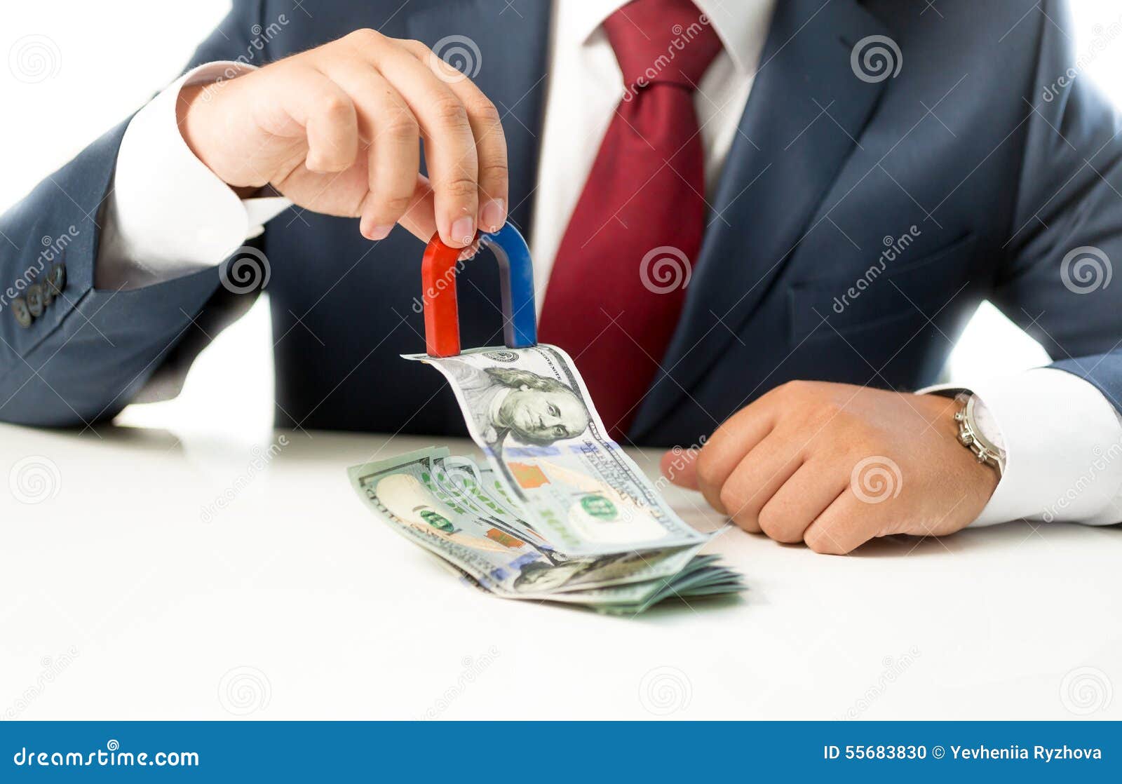 Businessman Pulling Money from Stack on Table with the Magnet Stock ...