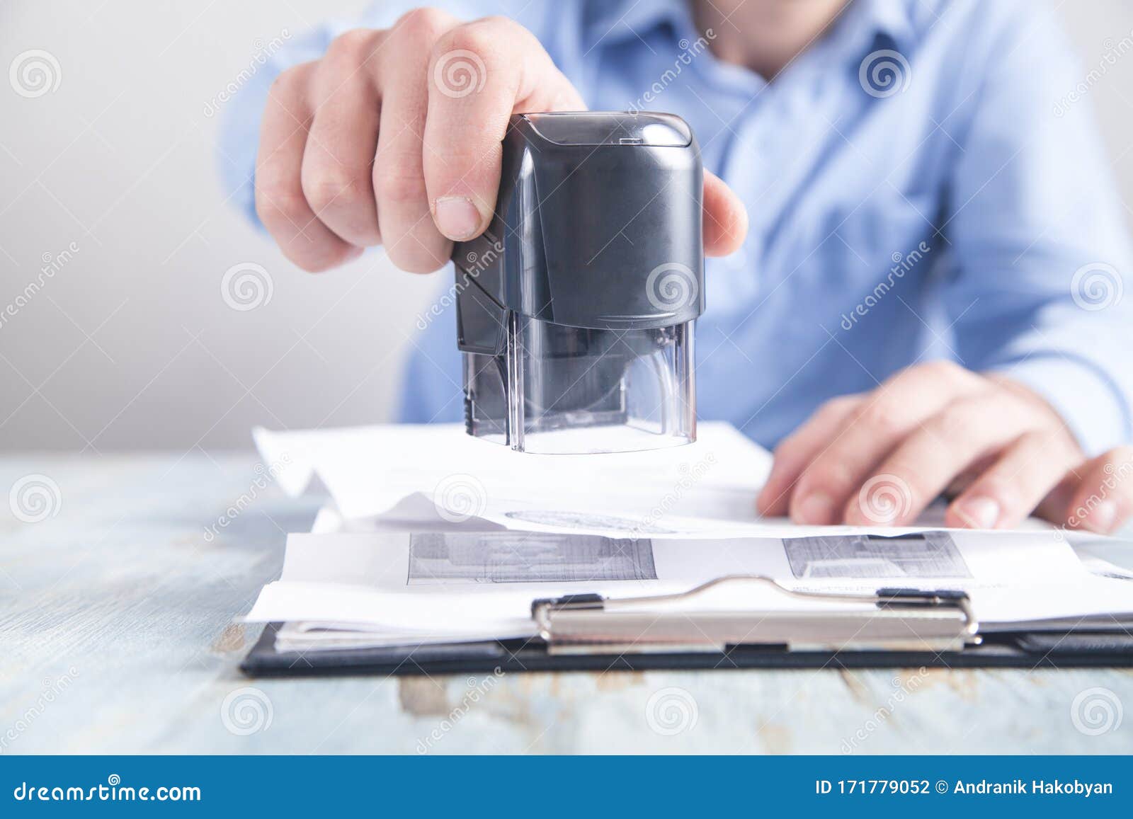 Businessman Puts a Stamp on the Documents in the Office Stock Photo ...
