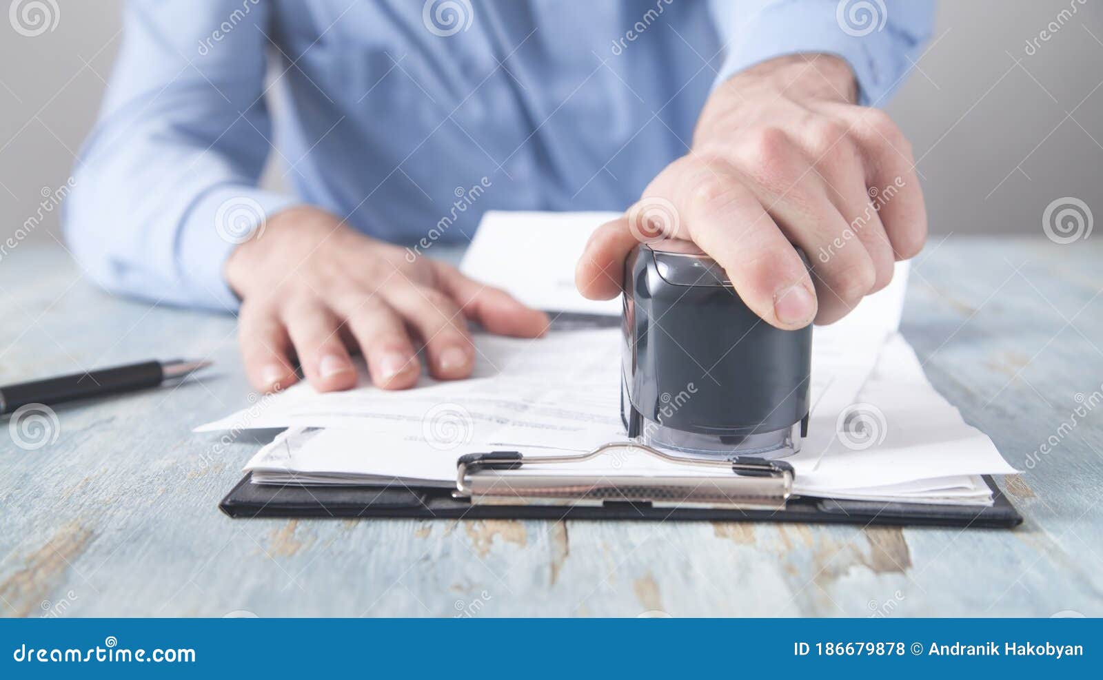 Businessman Puts a Stamp on the Documents in the Office Stock Photo ...