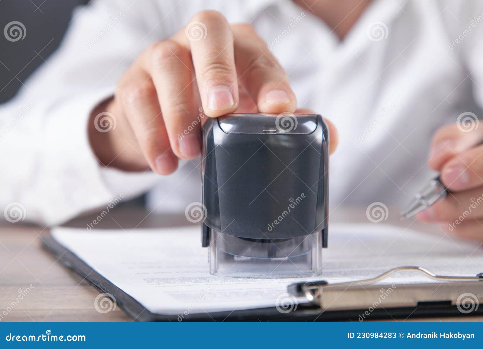 Businessman Puts a Stamp on the Documents in the Office Stock Image ...