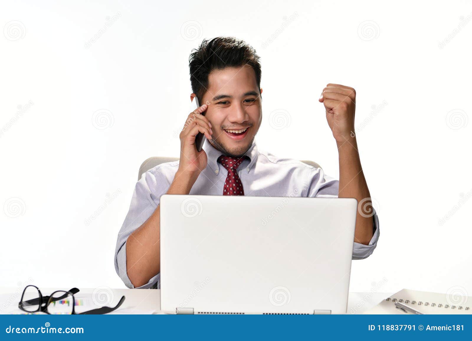 Businessman Raising His Hand while Talking on the Phone Feeling Happy ...