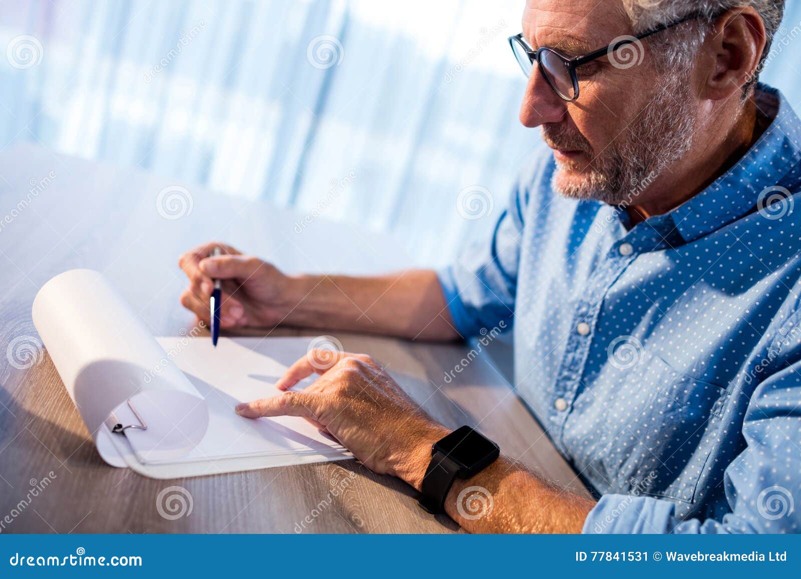 Businessman Reading a Document Stock Image - Image of male, focused ...