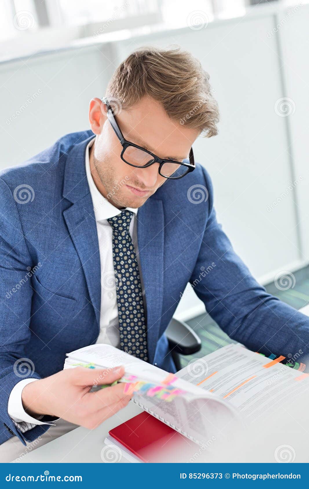 Businessman Reading File at Desk in Creative Office Stock Image - Image ... Businessman Reading File at Desk in Creative Office Stock Image - Image ...