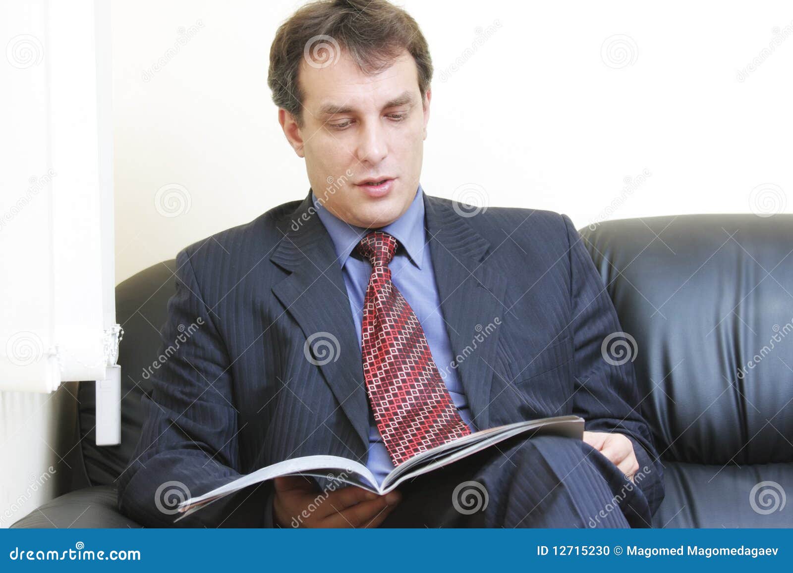 Businessman Reading Magazine Stock Photo - Image of office, black: 12715230