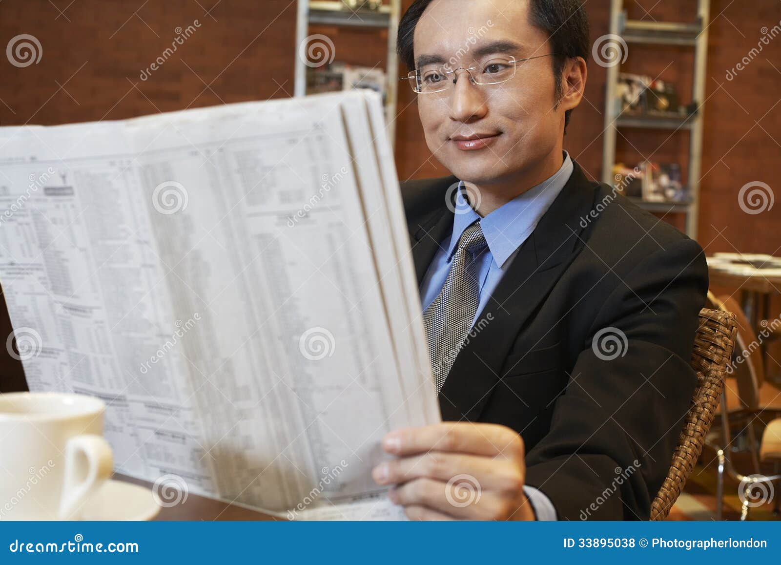 Businessman Reading Newspaper at Cafe Table Stock Photo - Image of ...