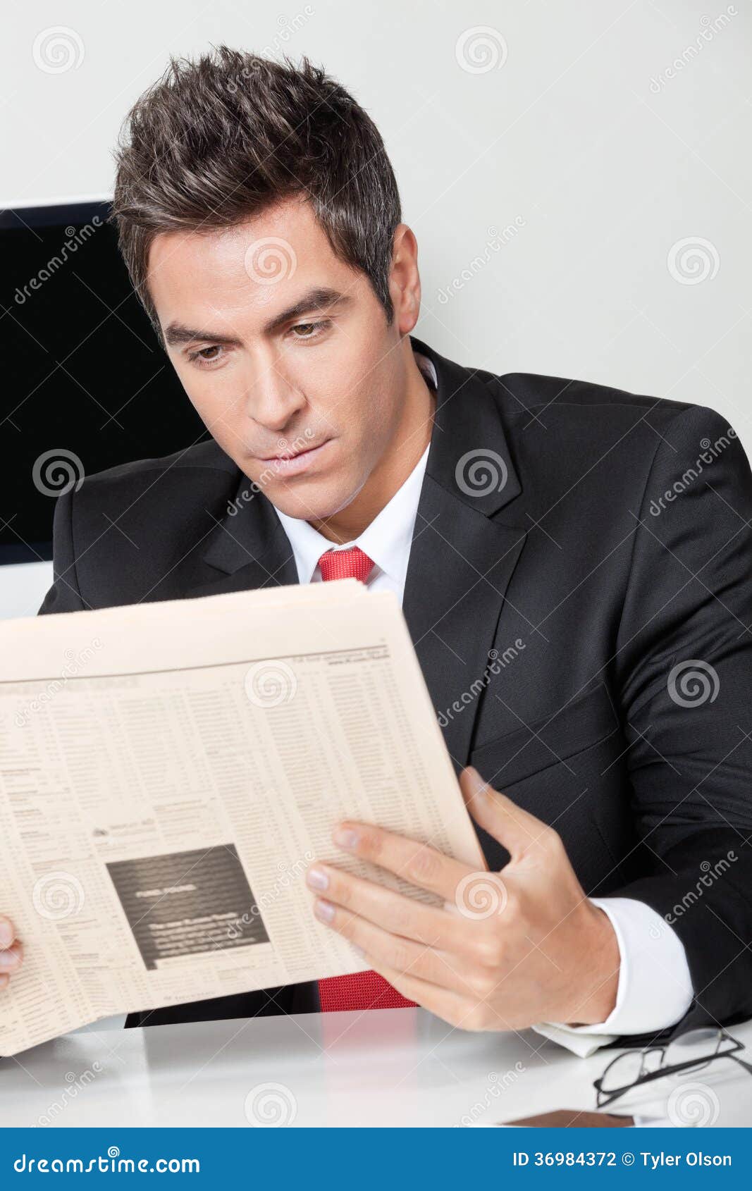 Businessman Reading Newspaper in Office Stock Photo - Image of young ...