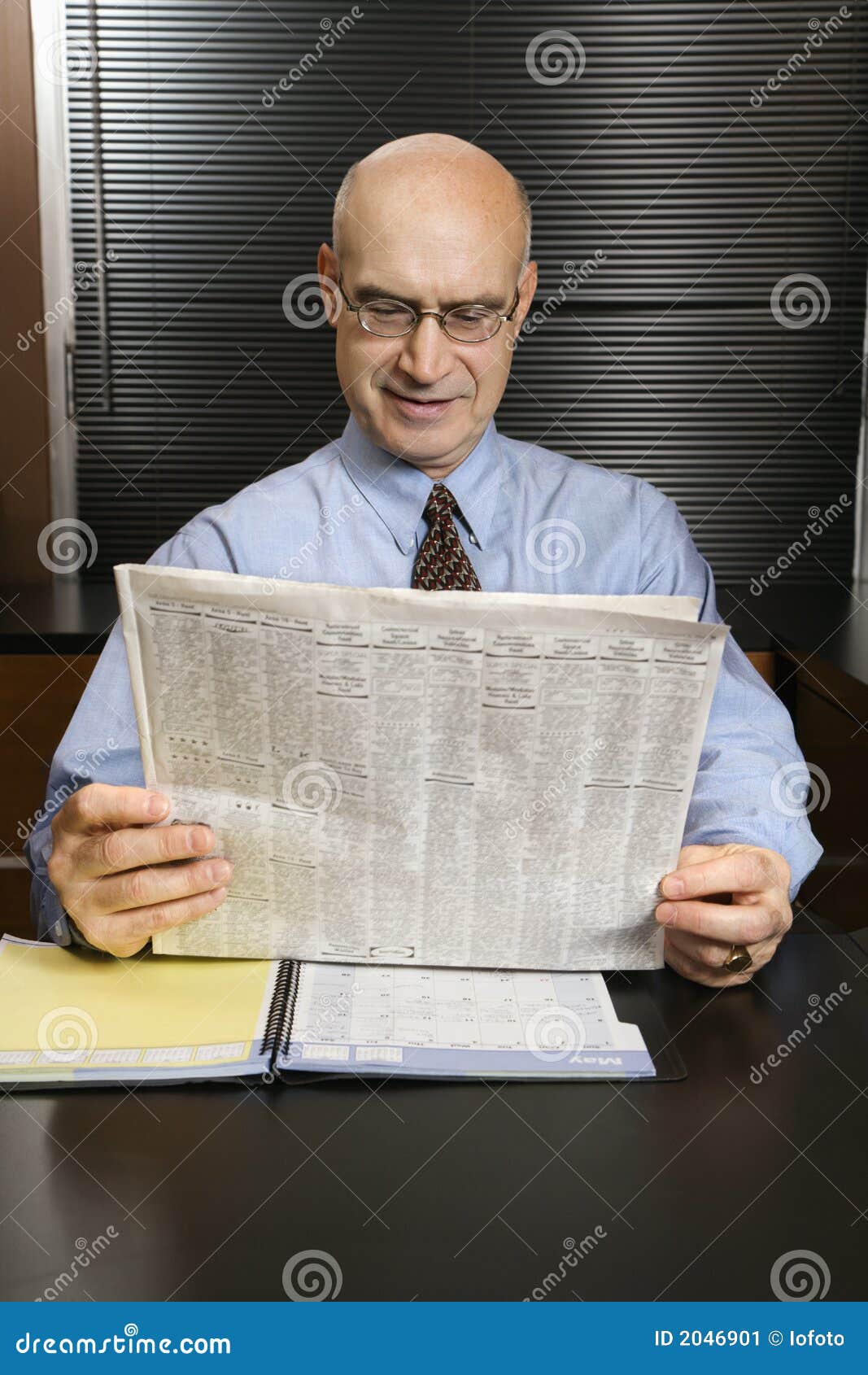 Businessman reading paper stock image. Image of bald, serene - 2046901