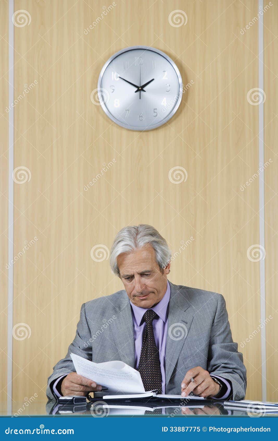 Businessman Reading Papers in Office Stock Image - Image of businessman ...