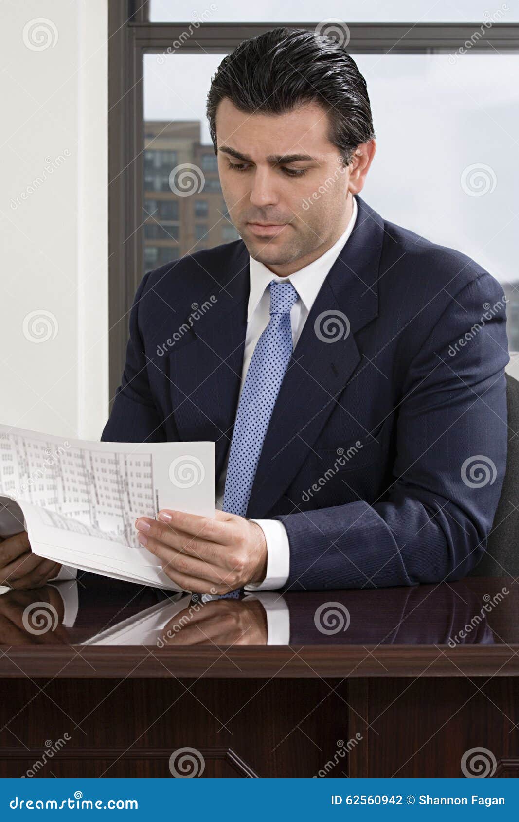 Businessman reading report stock photo. Image of file - 62560942