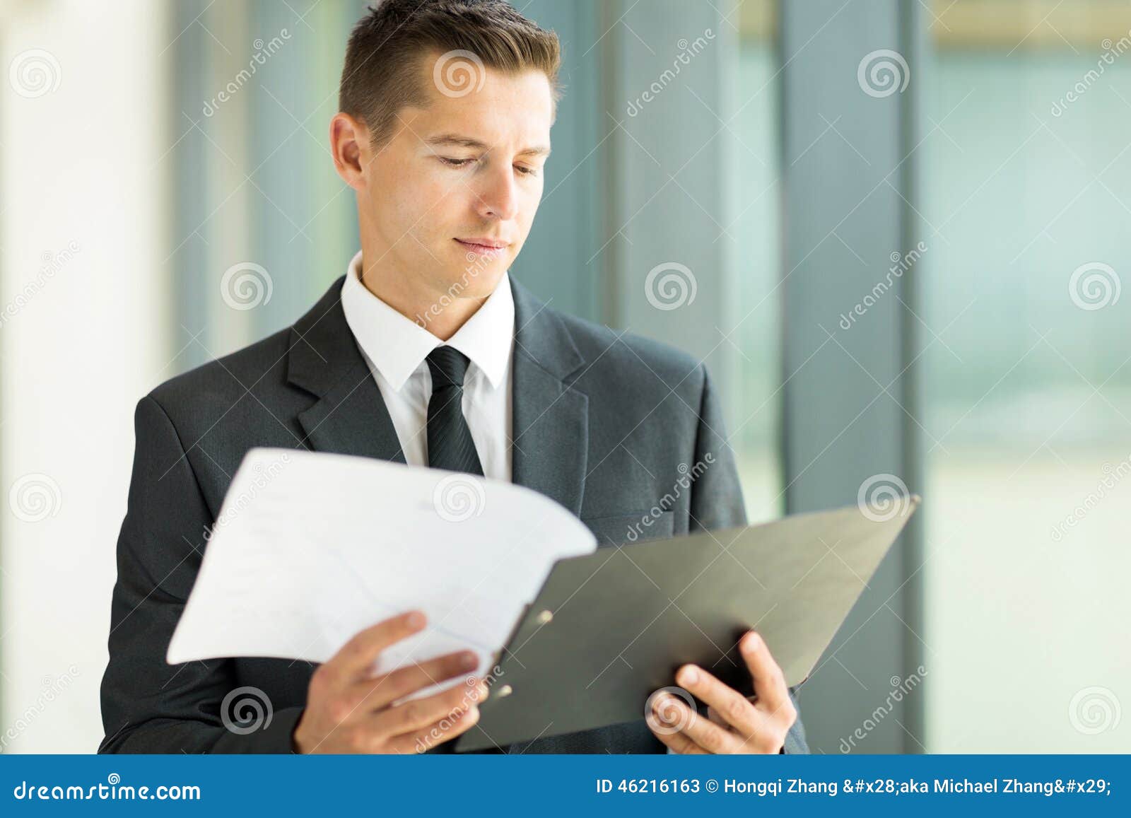 Businessman reading report stock image. Image of businessperson - 46216163