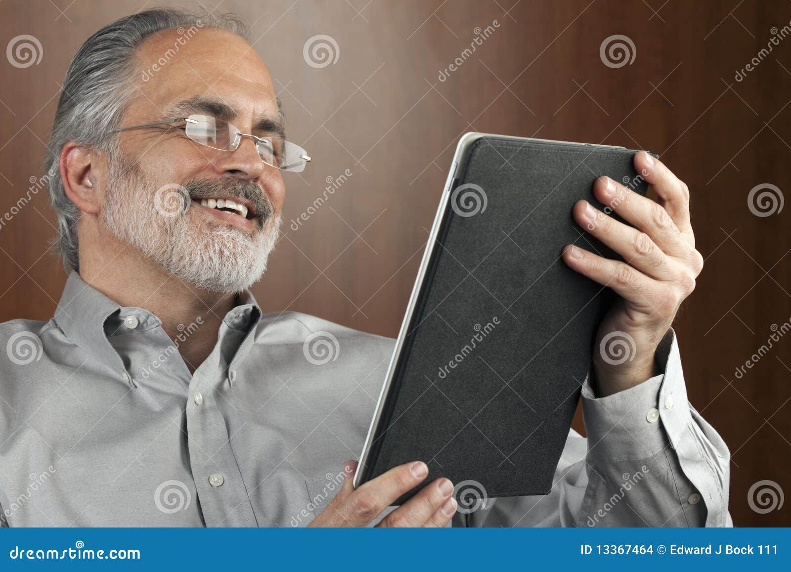 Businessman Reading from a Tablet Stock Photo - Image of inside, facial ...