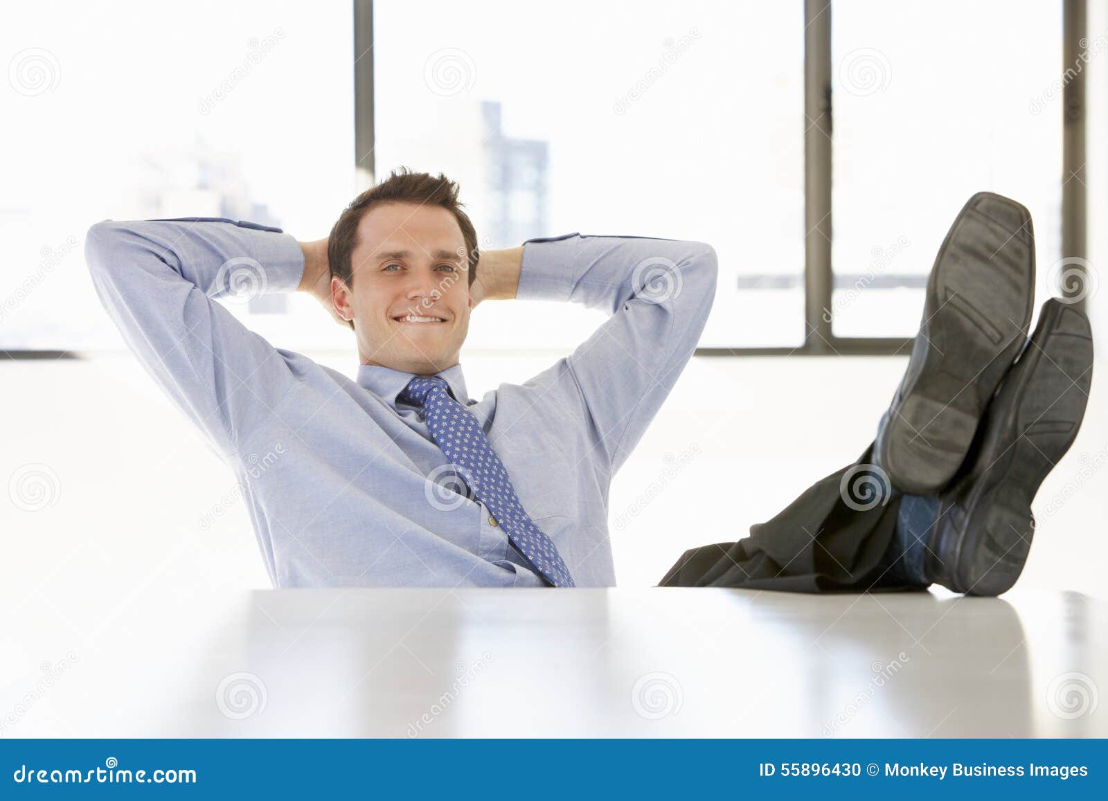 Businessman Relaxing at Desk in Office Stock Photo - Image of worker ...