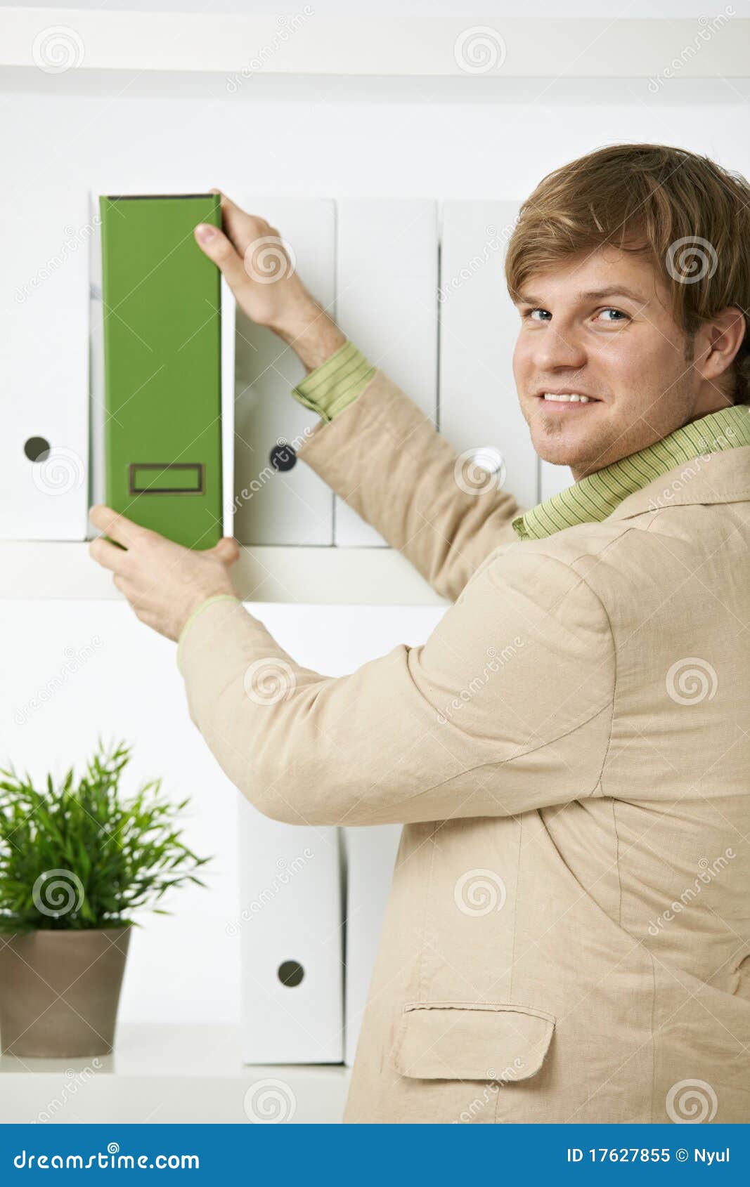 Businessman Removing Green Folder from Shelf Stock Image - Image of ...