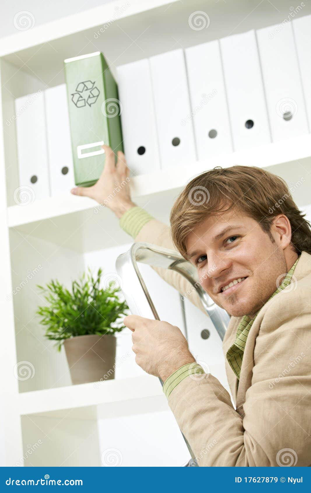 Businessman Removing Green Folder from Shelf Stock Image - Image of ...
