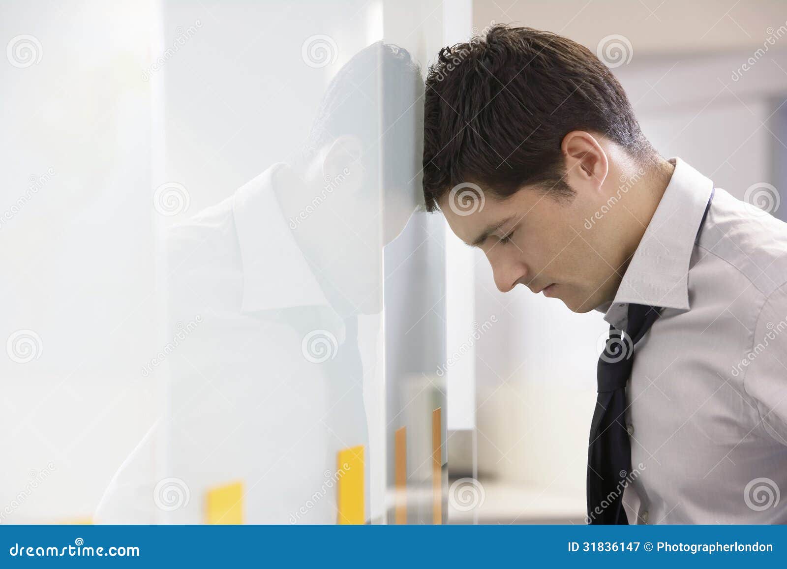 Businessman Resting Head Against Wall Stock Image - Image of shirt ...