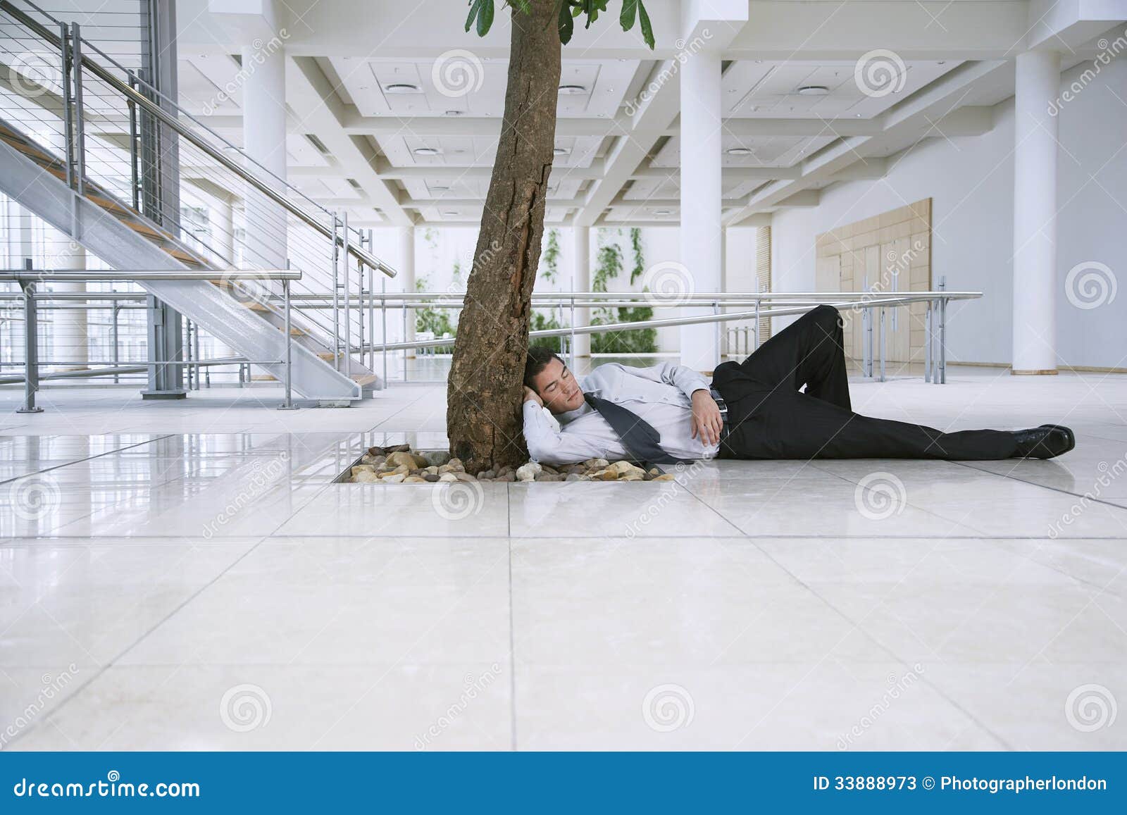Businessman Resting Under Tree in Office Stock Image - Image of ...
