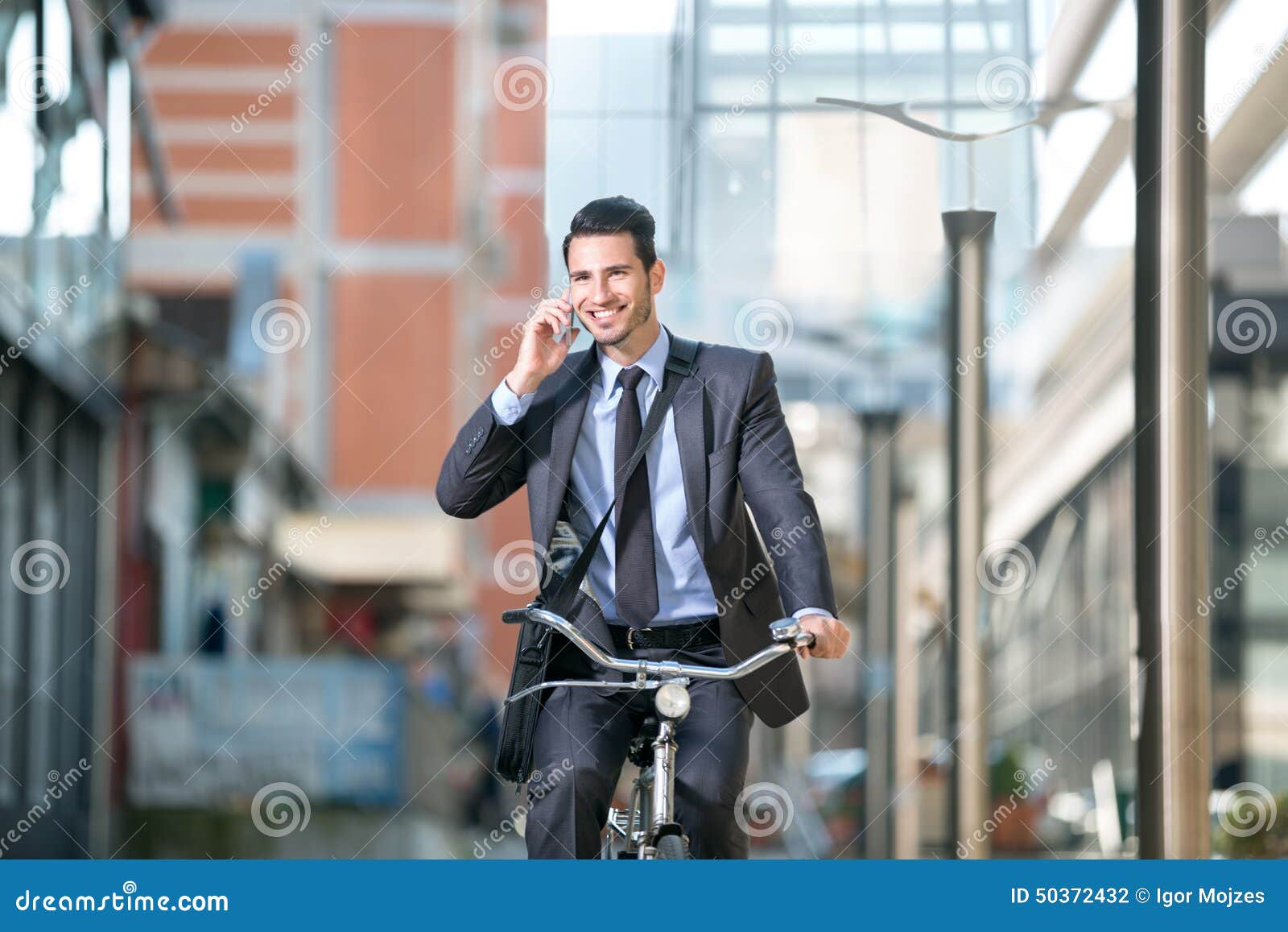 Businessman Riding a Bicycle and Talking with Mobile Phone Stock Photo ...