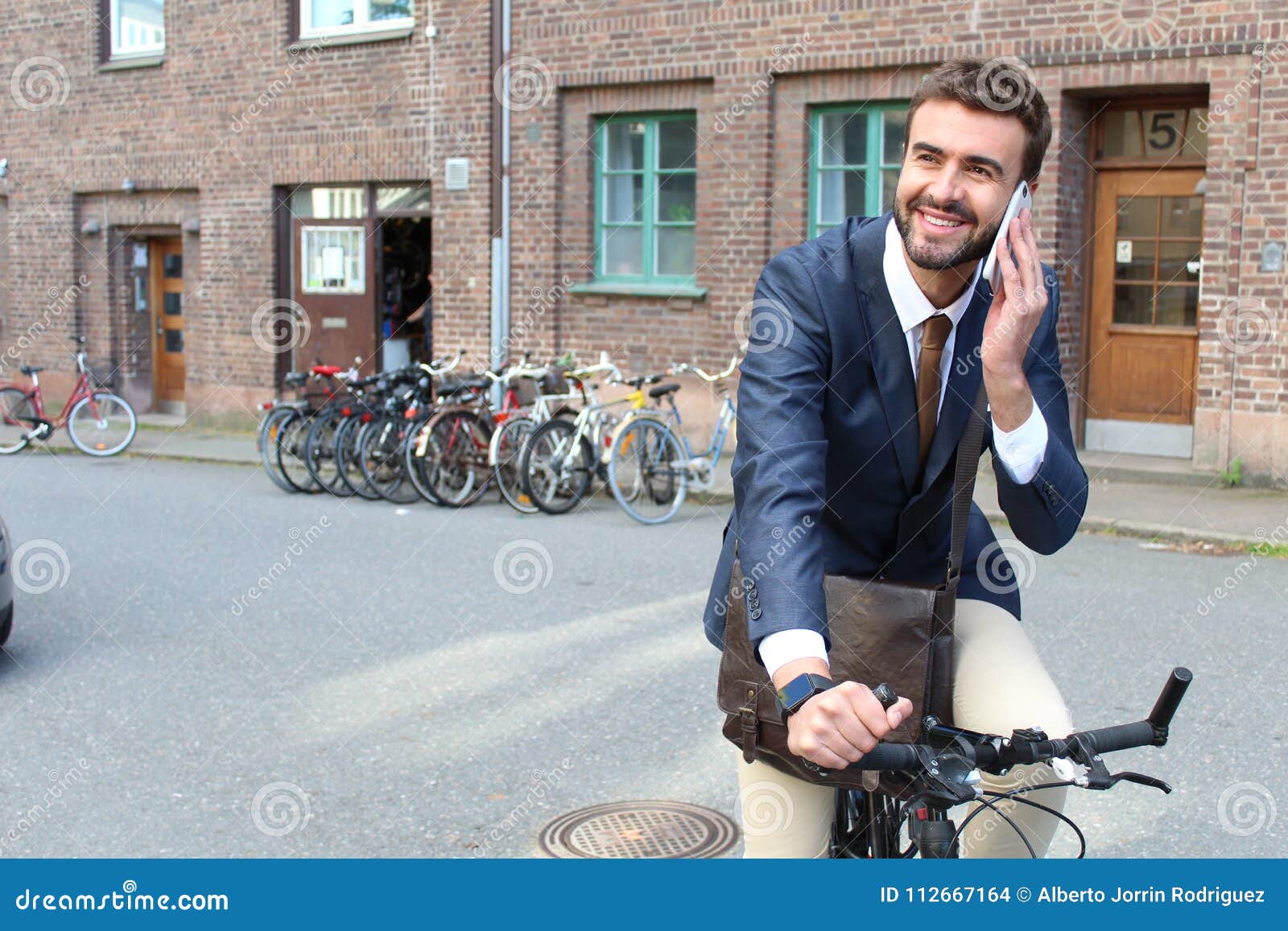 Businessman Riding a Bicycle while Talking on the Phone Stock Photo ...