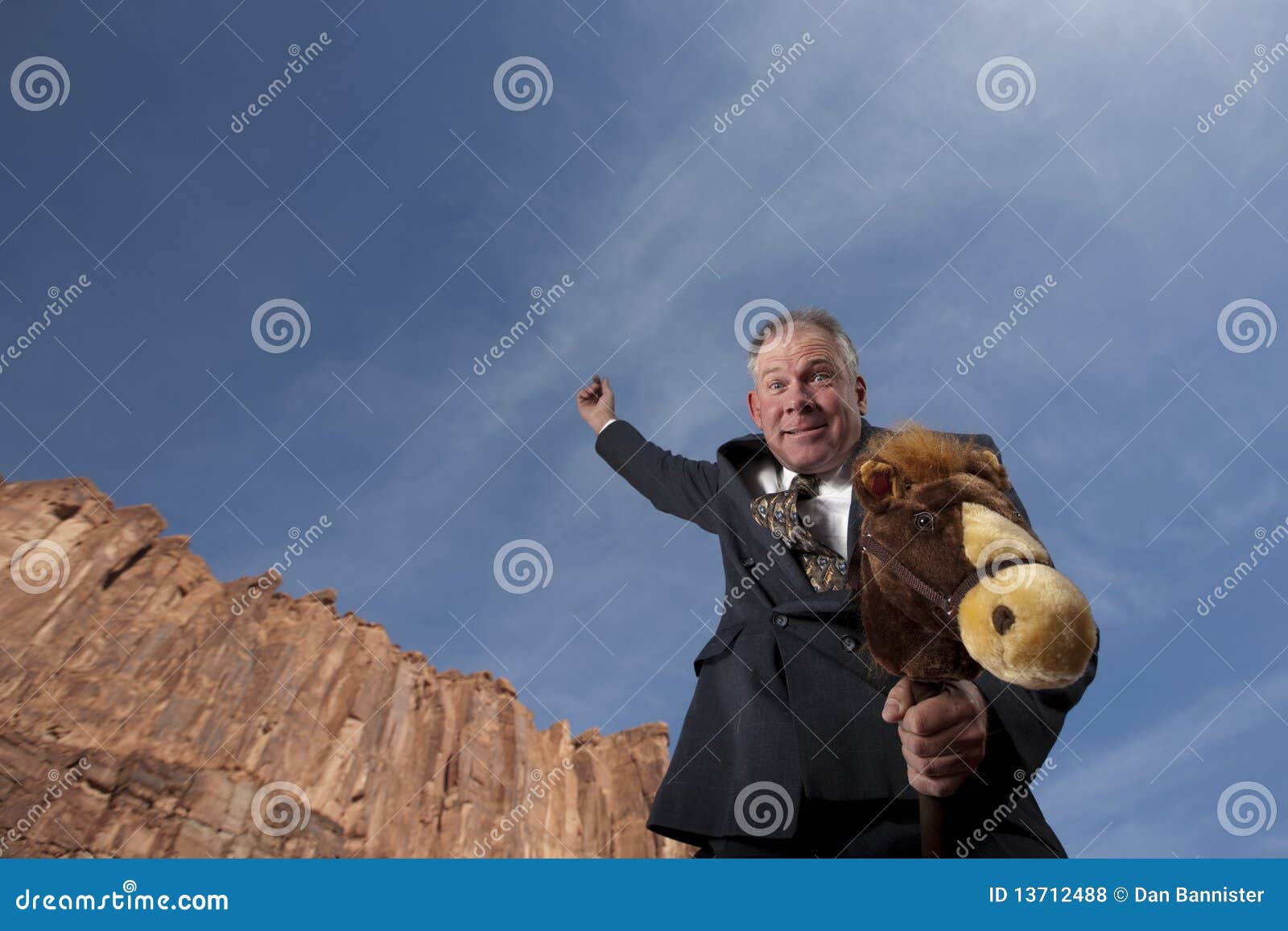 Businessman Riding a Stick Horse Stock Photo - Image of crazy, camera ...