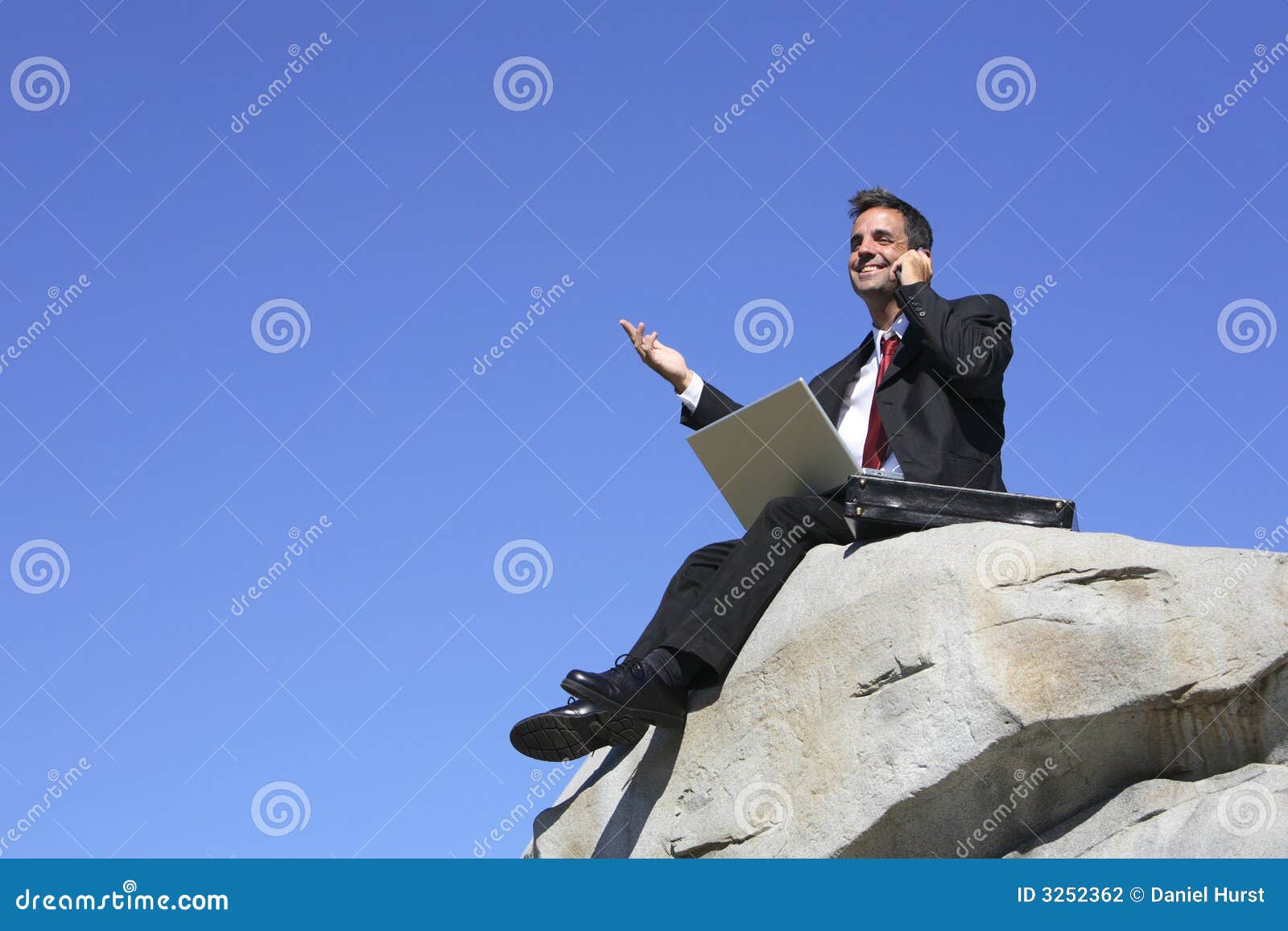 Businessman on a rock stock photo. Image of blue, people - 3252362