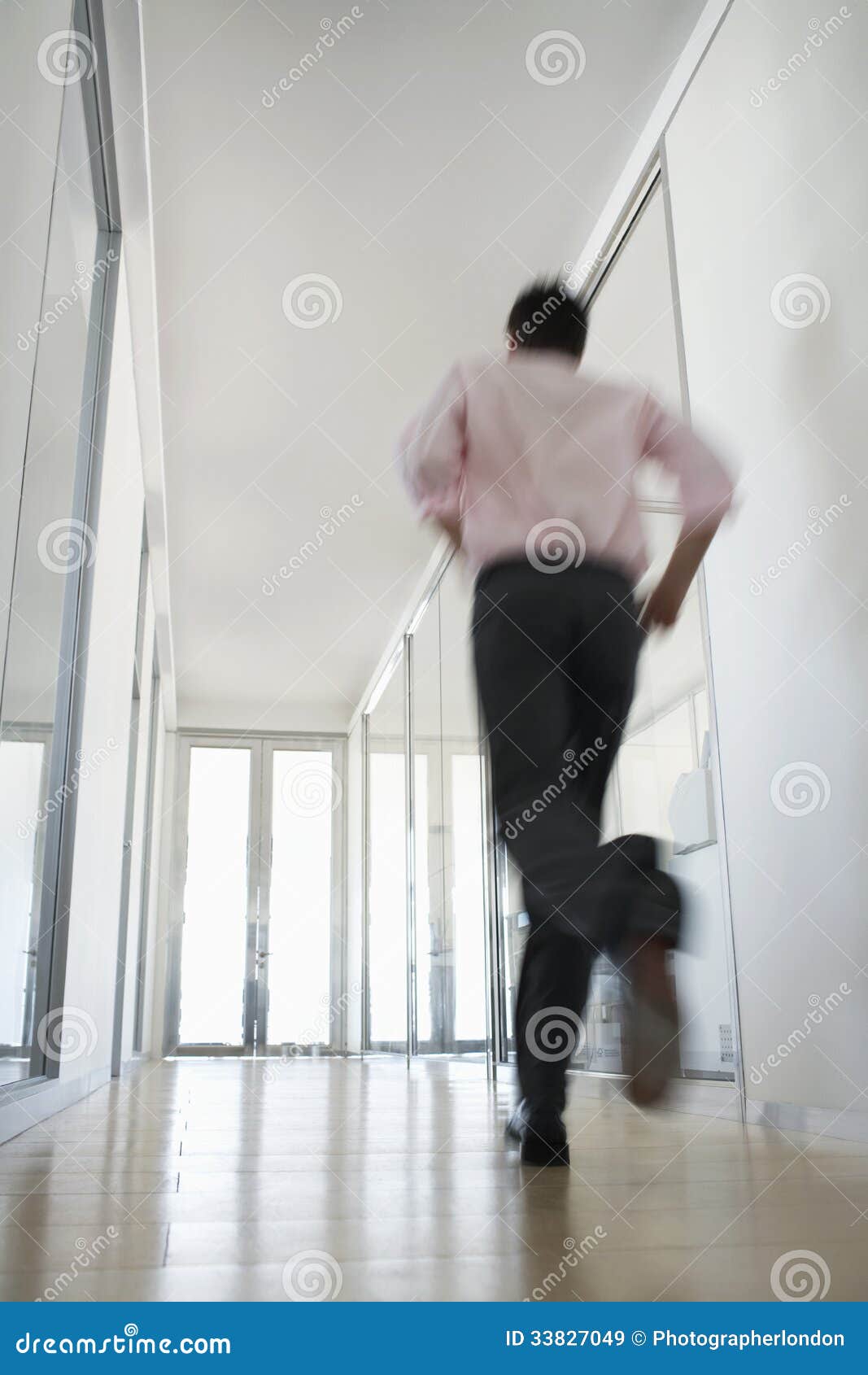Businessman Running in Corridor Stock Image - Image of rear ...