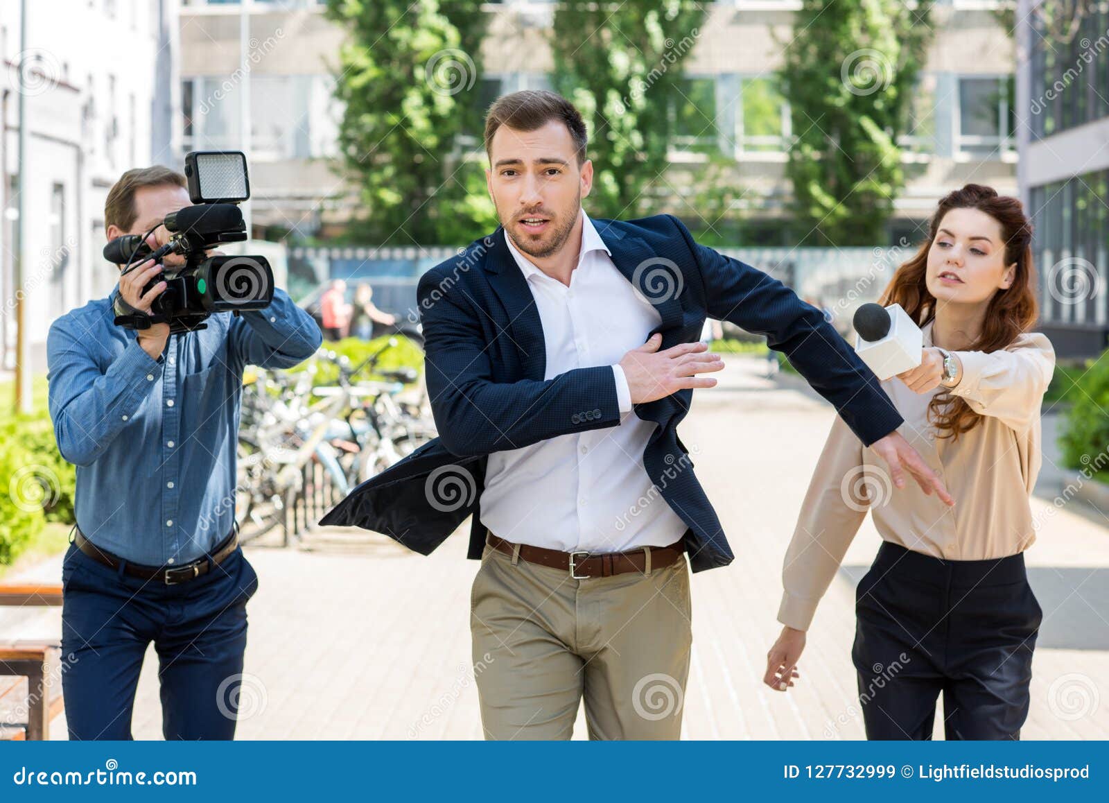 Businessman Running from Journalists with Digital Video Camera Stock ...