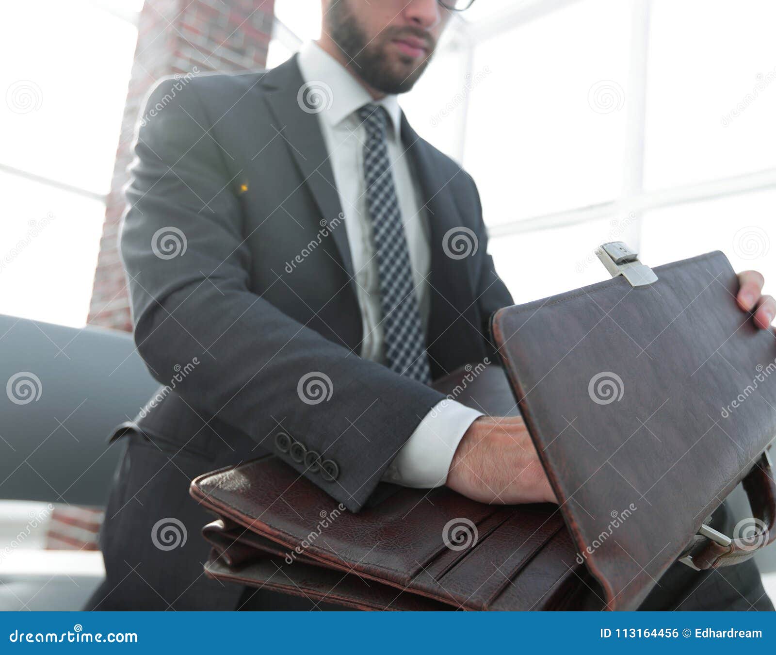 Businessman`s Hand with Suitecase in a Modern Office Stock Photo ...
