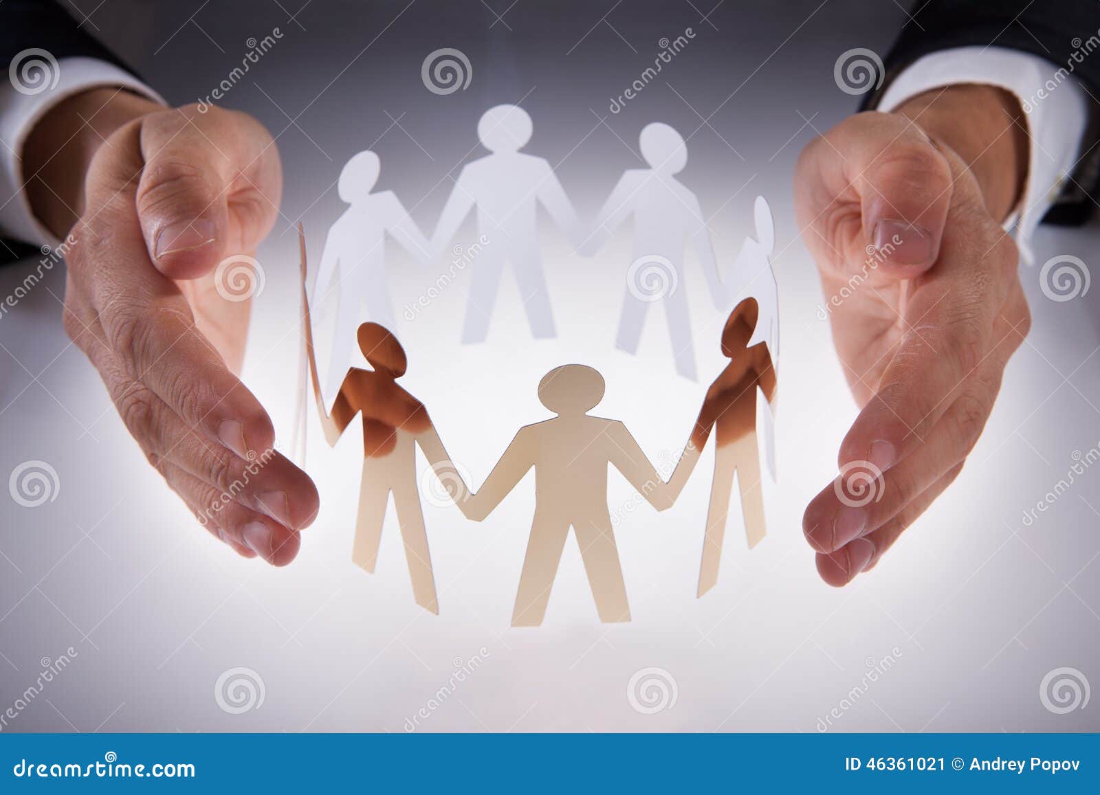 Businessman S Hands Protecting Team of Paper People on Desk Stock Image ... Businessman S Hands Protecting Team of Paper People on Desk Stock Image ...
