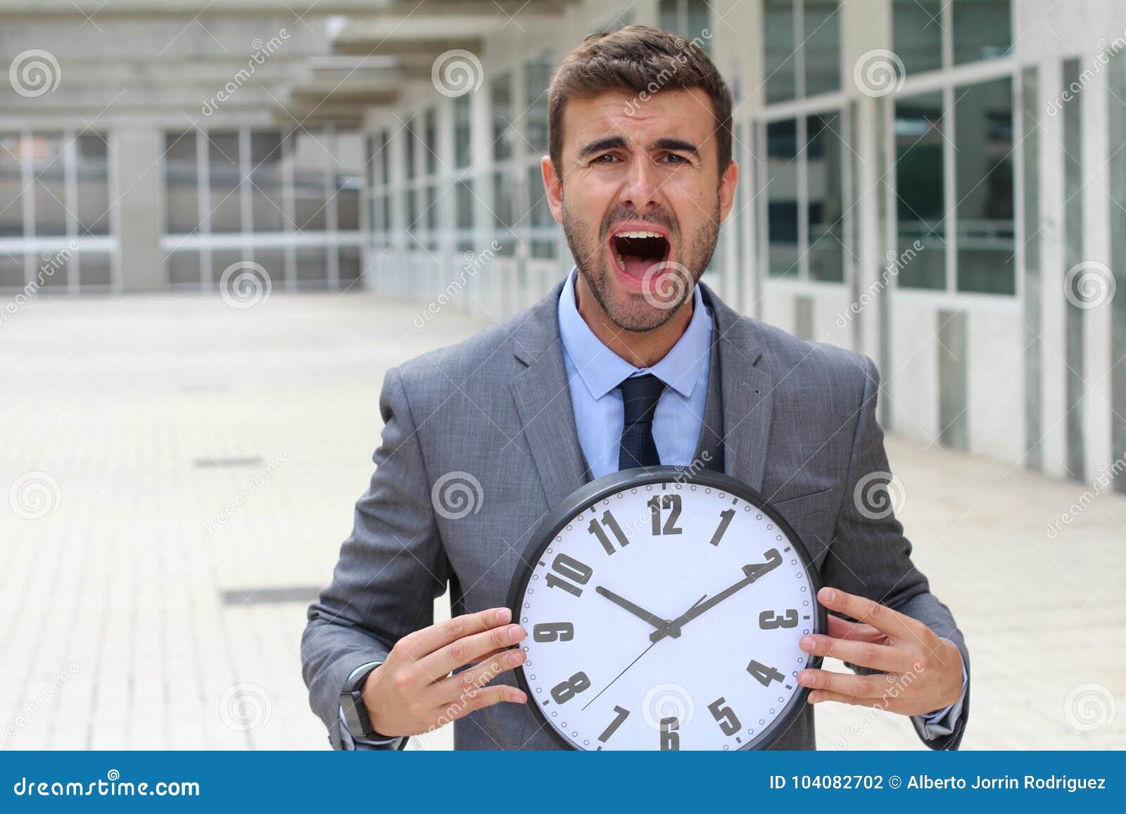 Businessman Screaming while Holding a Big Clock Stock Photo - Image of ...