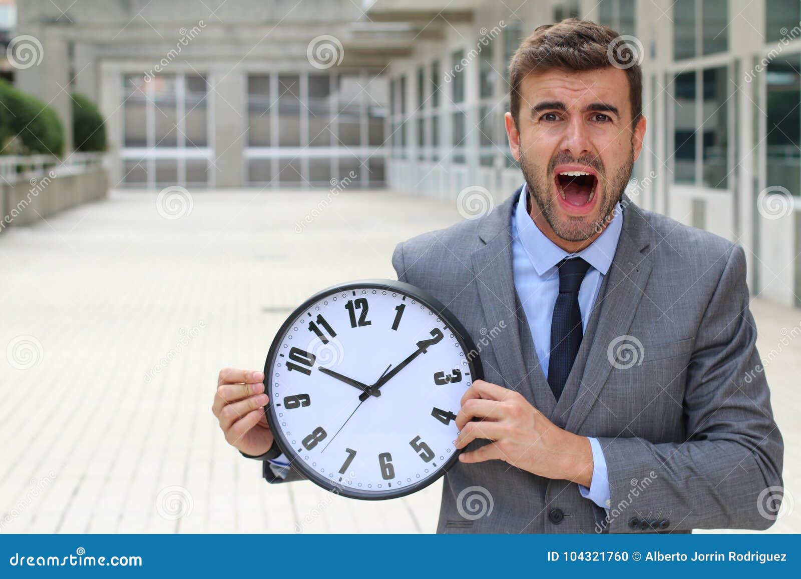 Businessman Screaming while Holding a Big Clock Stock Photo - Image of ...