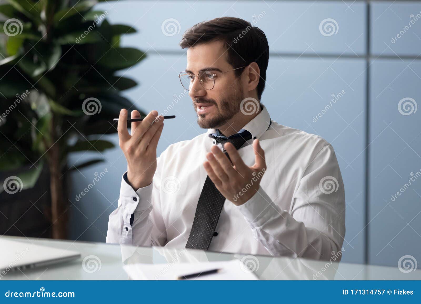 Businessman Holding Smartphone Speaking through Microphone Sending ...