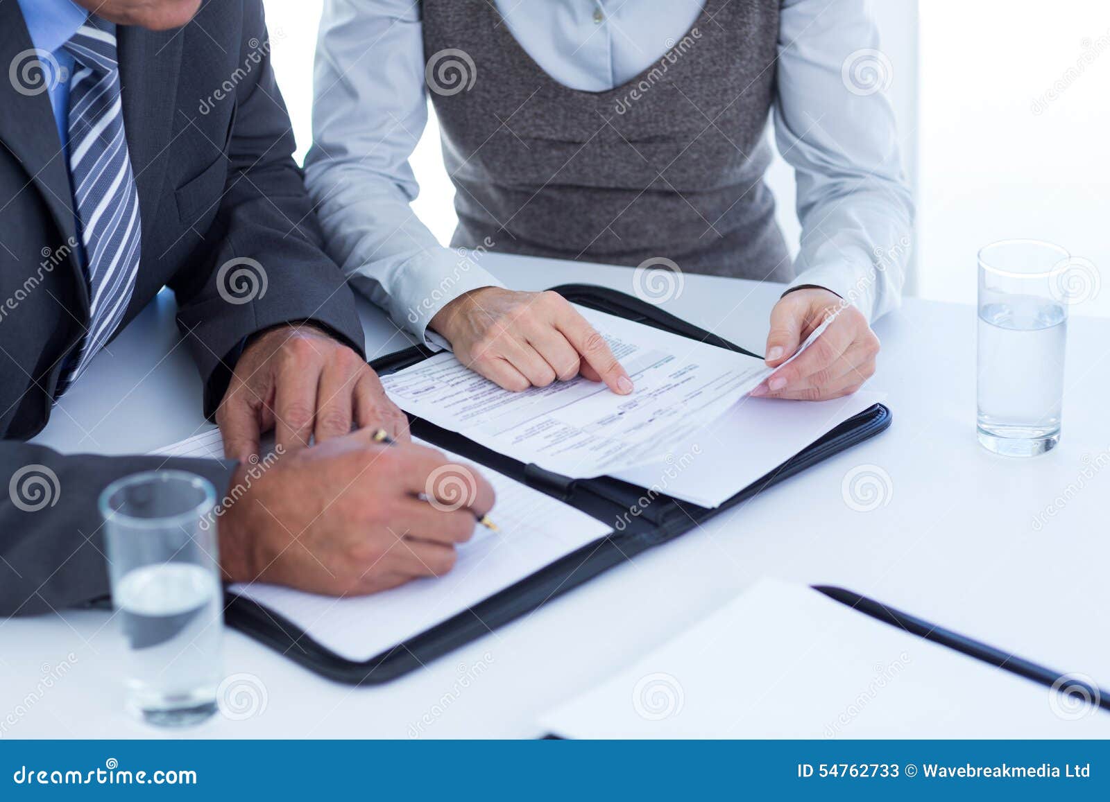 Businessman with Secretary Checking File Stock Image - Image of ...