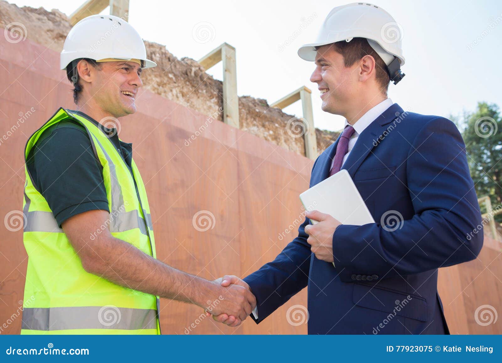 Hands Of A Builder In His Orange Gloved Hands Fitting Laying New ...