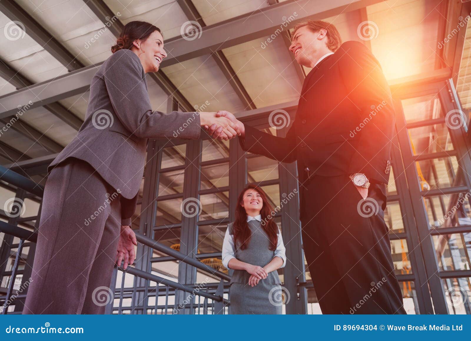 Businessman Shaking Hands with Female Partner Stock Photo - Image of ...