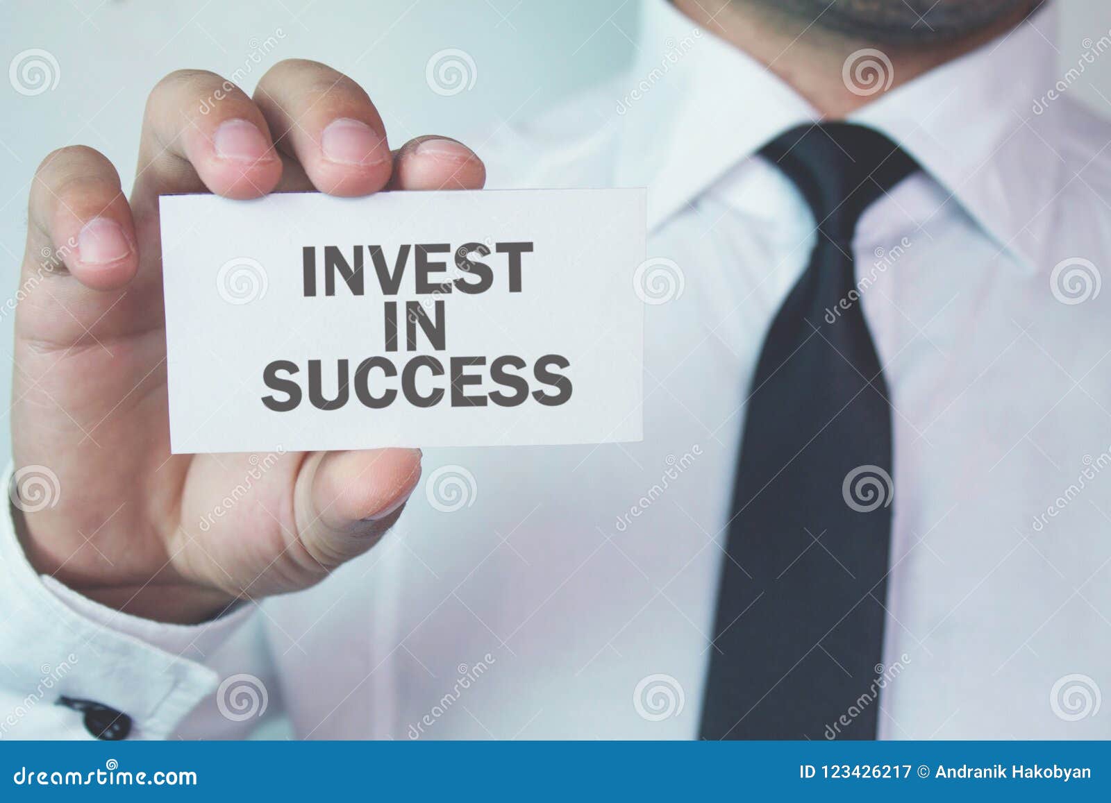 Businessman Showing Invest in Success Word on Business Card. Stock ... Businessman Showing Invest in Success Word on Business Card. Stock ...