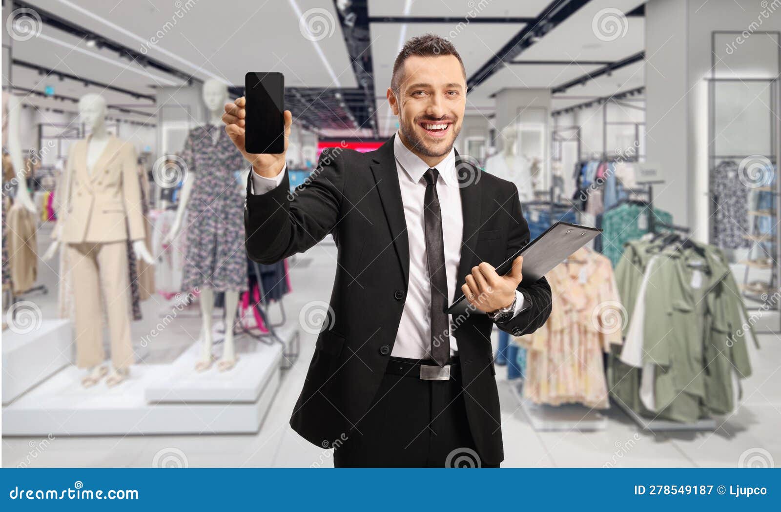 Businessman Showing a Mobile Phone in a Clothing Store Stock Image ...